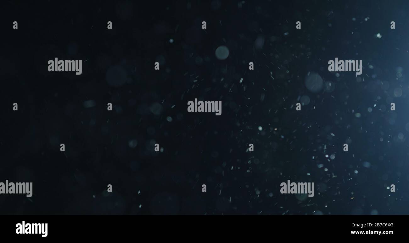 natural dust particles flow in air on black background, wide photo ...