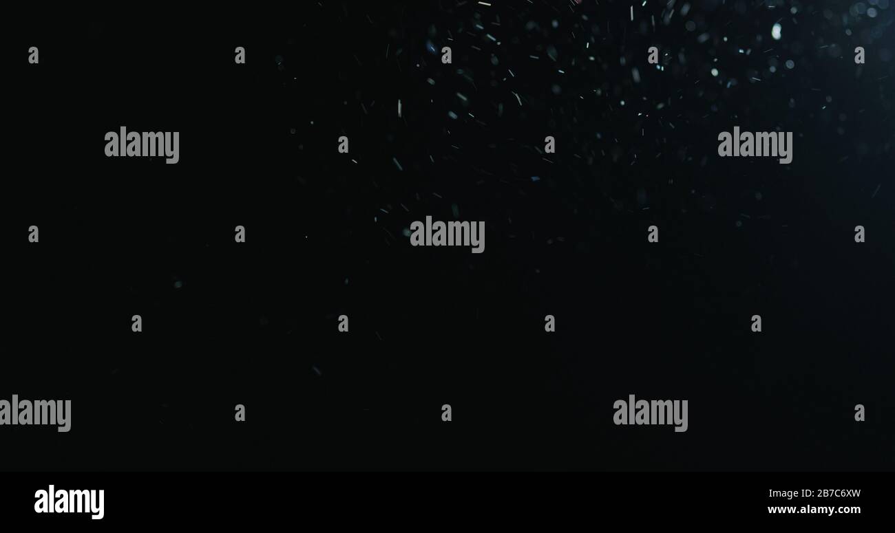 natural dust particles flow in air on black background, wide photo ...