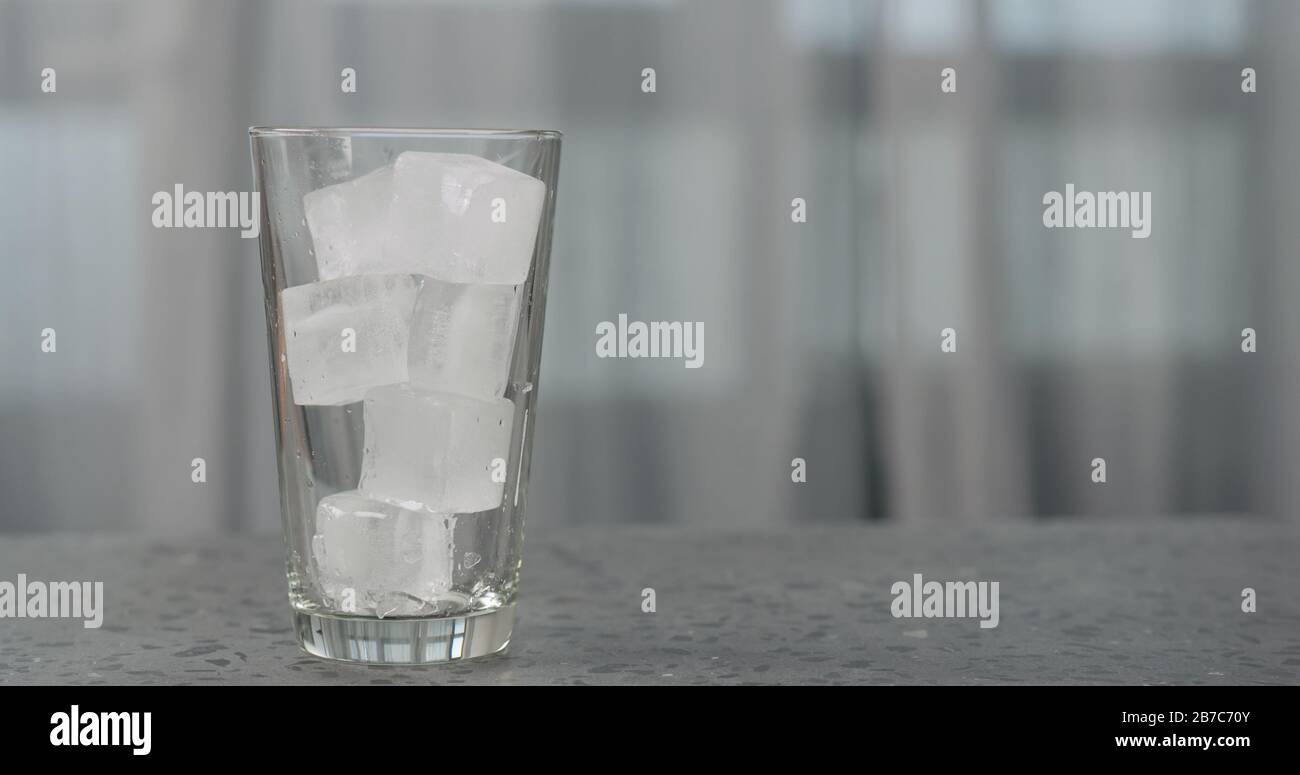 ice cubes in glass on concrete countertop, wide photo Stock Photo - Alamy