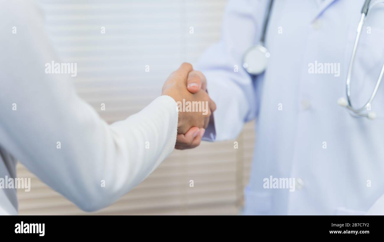 Doctor congratulating patient recovery hi-res stock photography and ...
