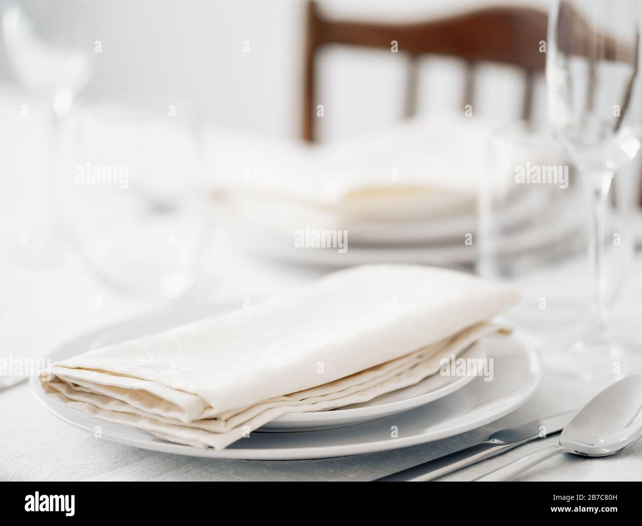 Beautiful table setting in white colors. Empty white plates. Set table ...