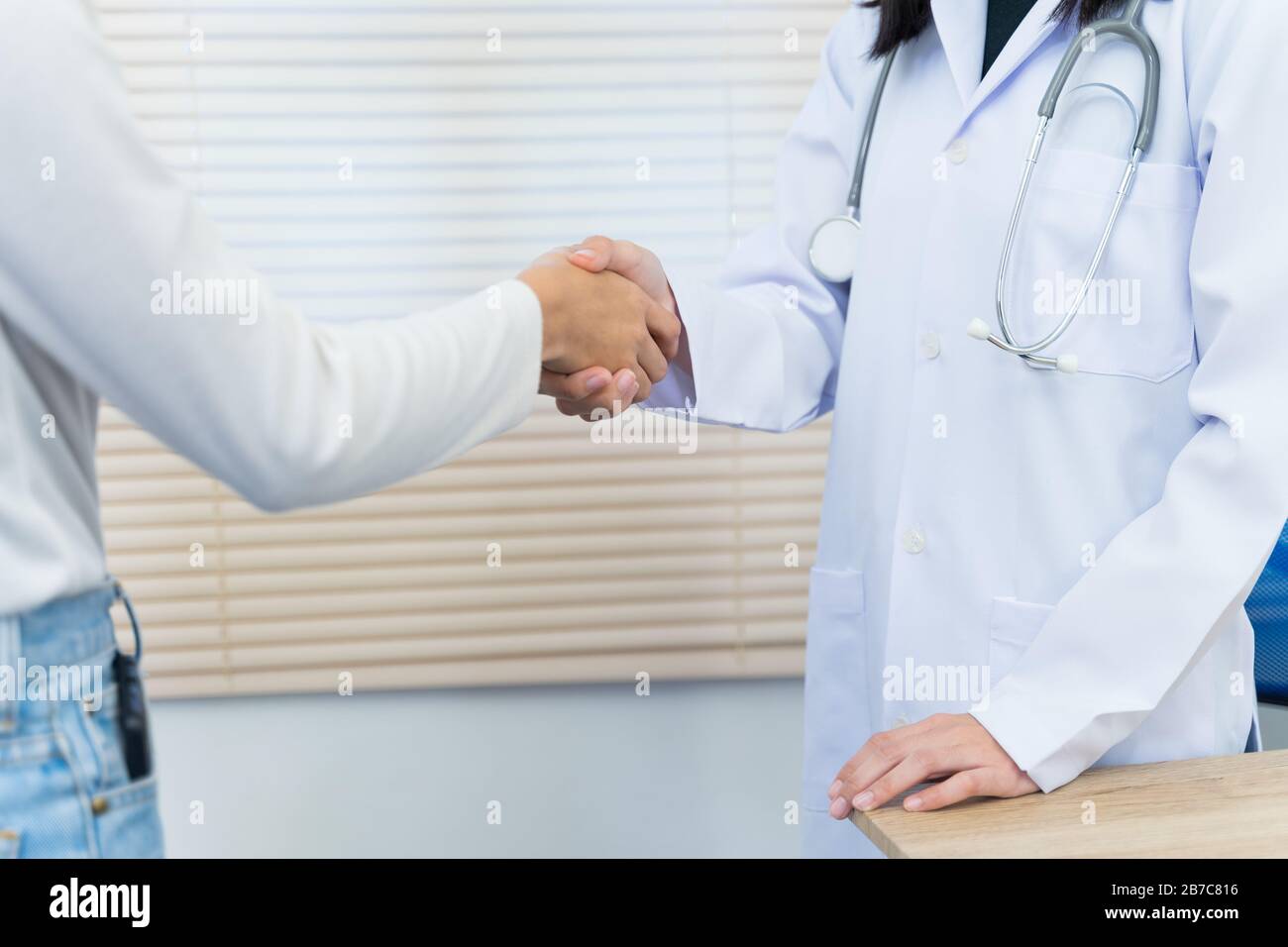 Doctor expressing his congratulations to the patient for illness ...