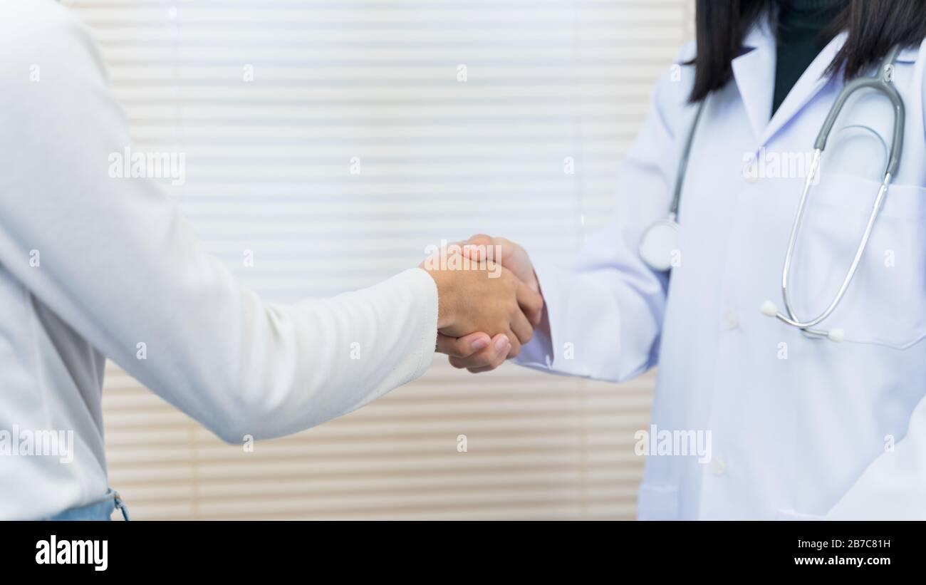 Doctor expressing his congratulations to the patient for illness ...