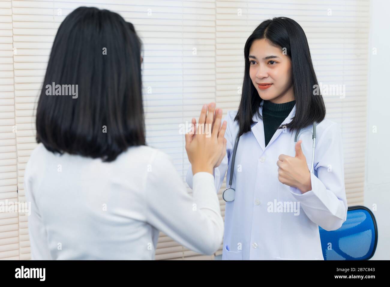 Doctor expressing his congratulations to the patient for illness ...