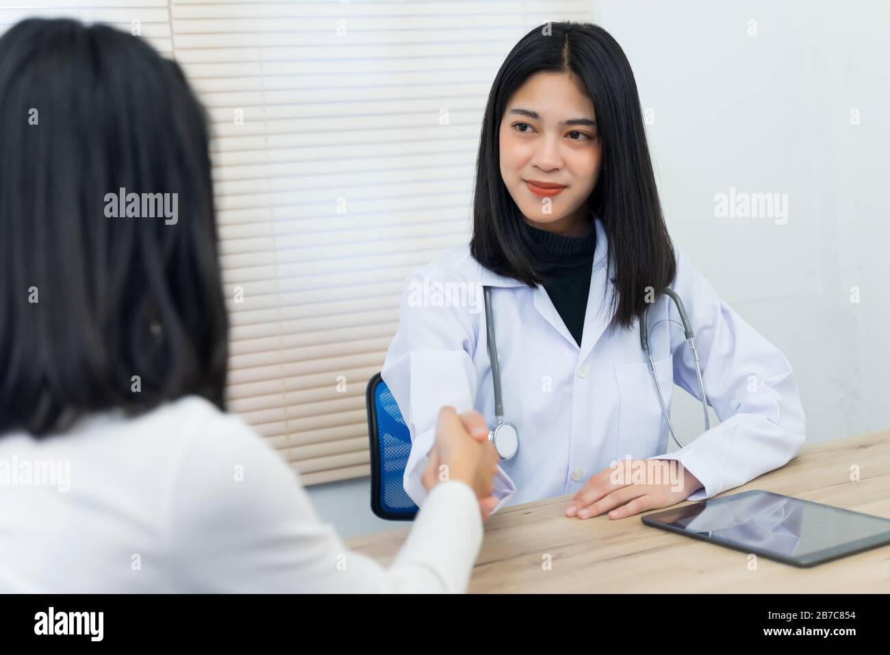 Doctor expressing his congratulations to the patient for illness ...