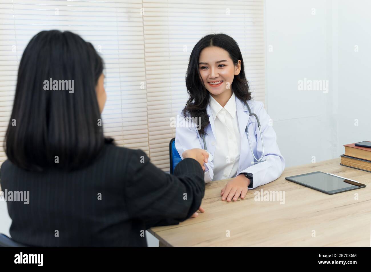 Doctor expressing his congratulations to the patient for illness ...