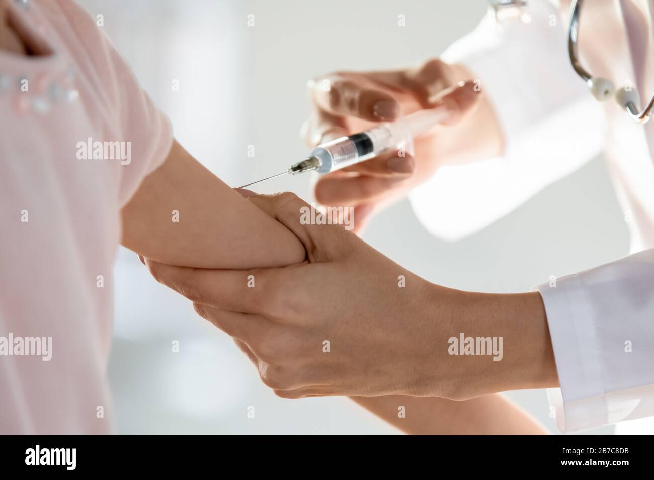 General practitioner making prick in arm of little patient Stock Photo ...