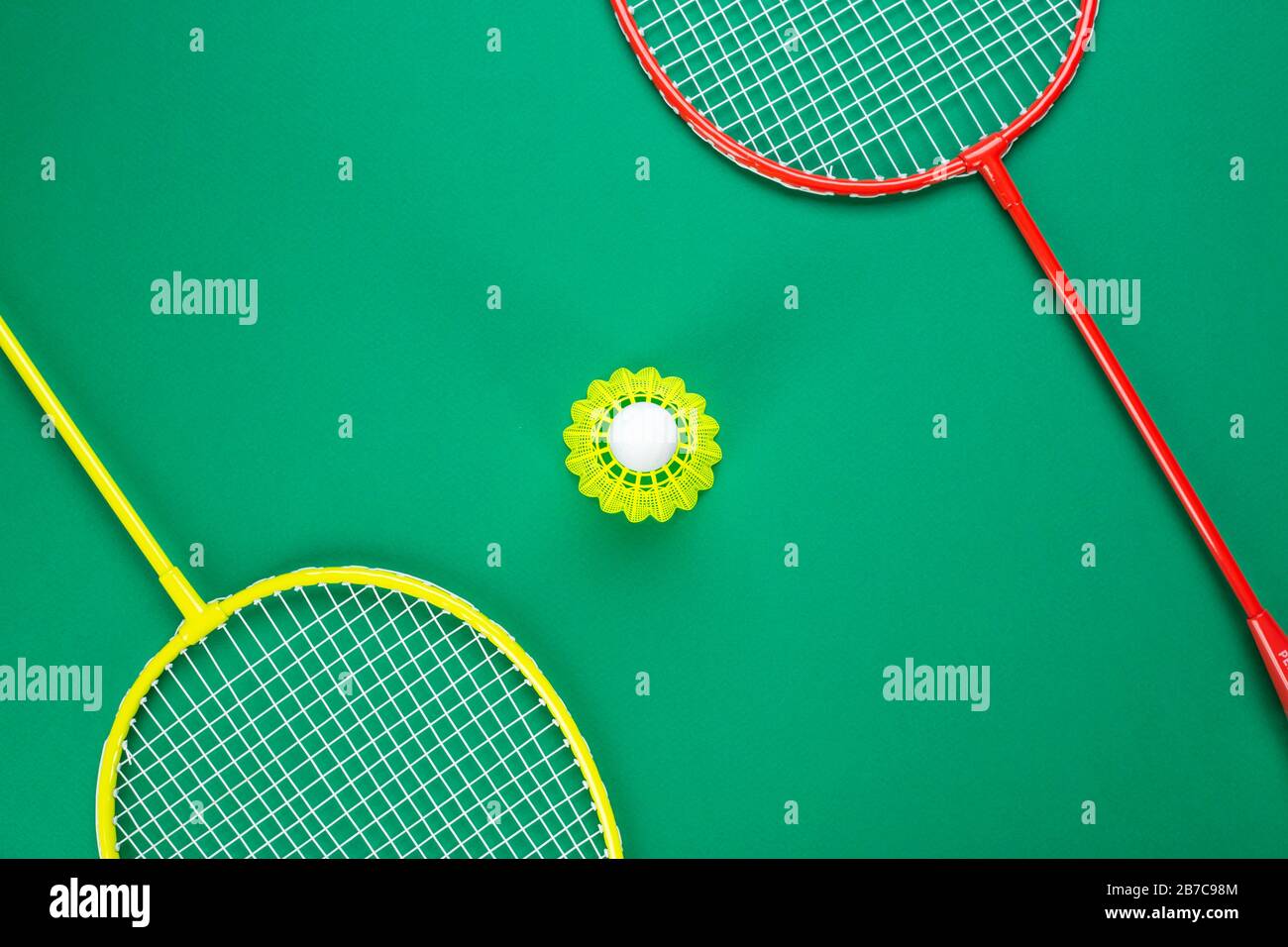 Shuttlecock and racket for playing badminton on a green background ...