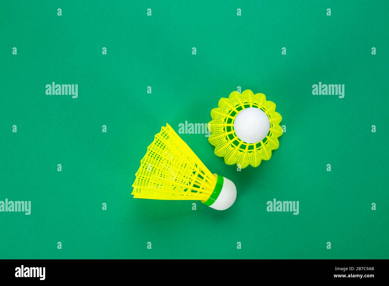 Two shuttlecock for badminton on a green background, top view. The ...