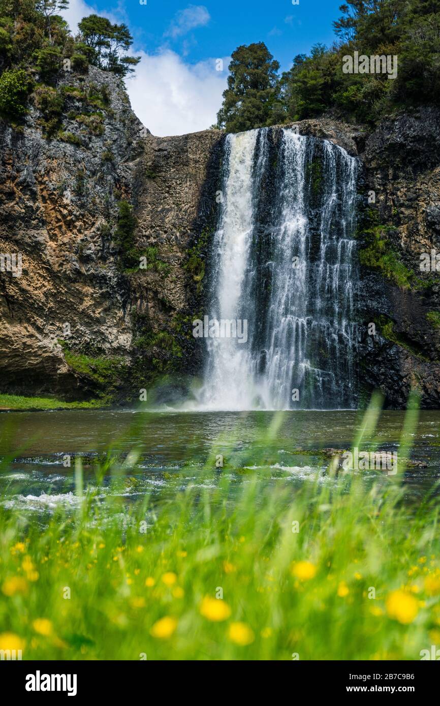 Beautiful scenery of a powerful waterfall flowing through a cliff into ...