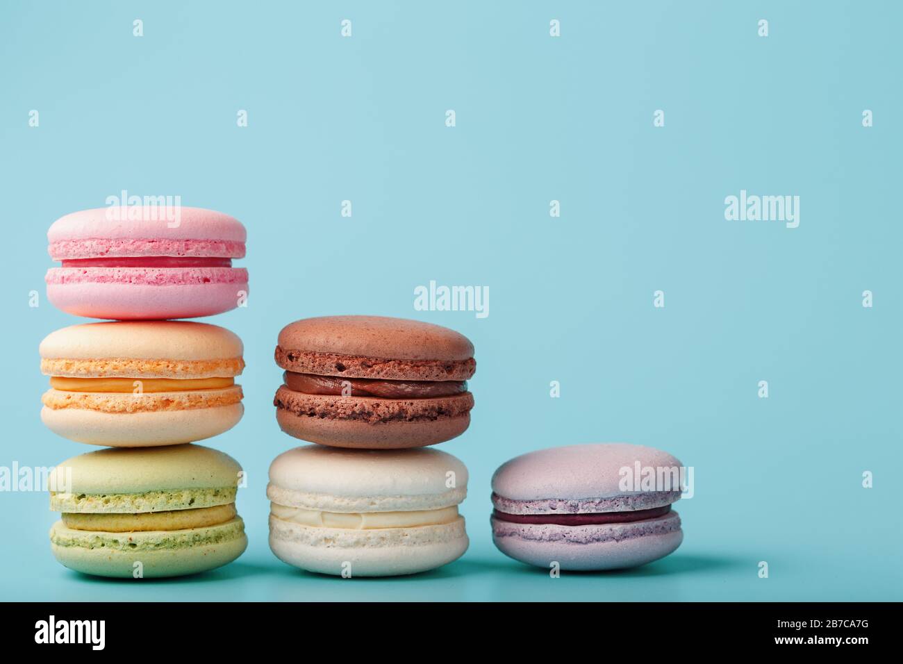 Macaroni cookies of different colors are arranged in the shape of ...