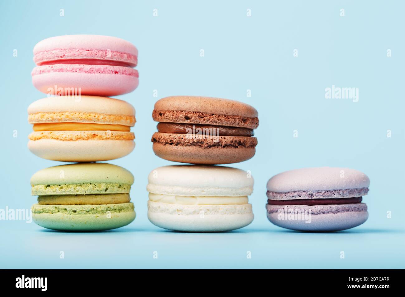 Macaroni cookies of different colors are arranged in the shape of ...