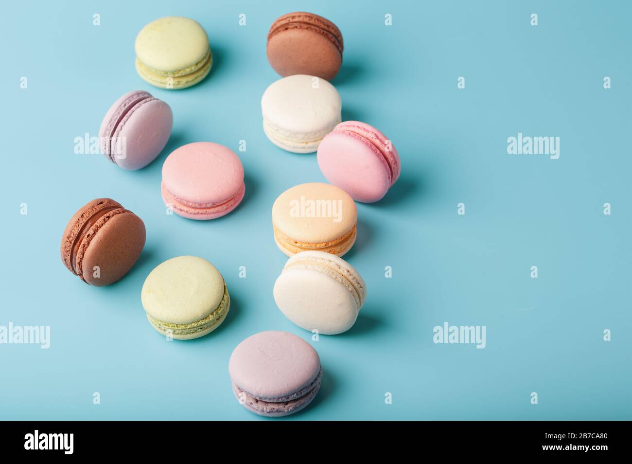 Multicolored French macaroni macaroni cookies on a blue background ...