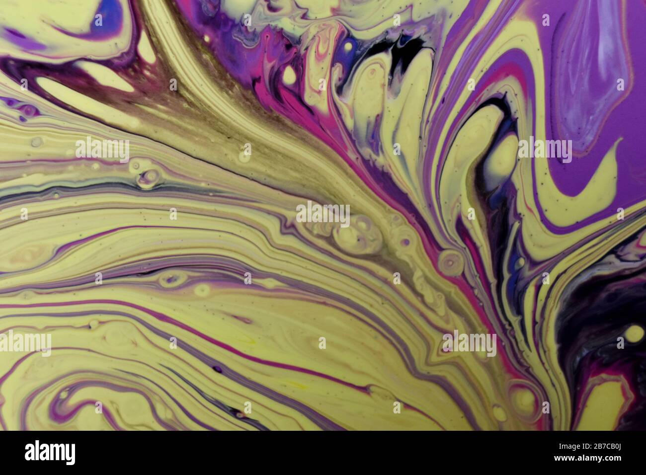 Closeup shot of an abstract background of colorful poured acrylic paint ...