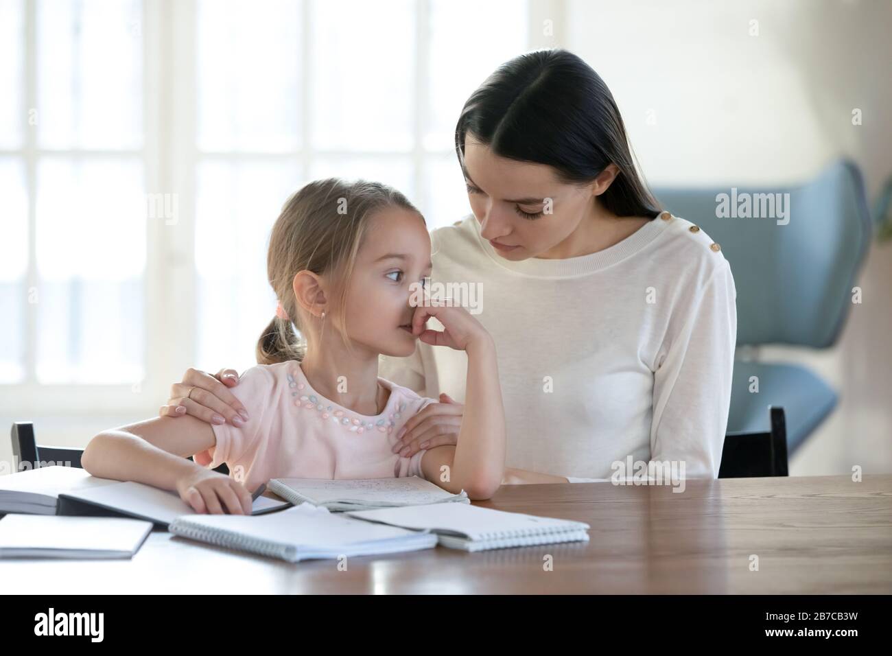 Unhappy little school girl stuck with hard task Stock Photo - Alamy