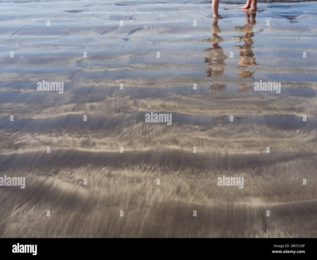 Wavy patterns of dark and golden sand on a beach in Tenerife, Canary ...