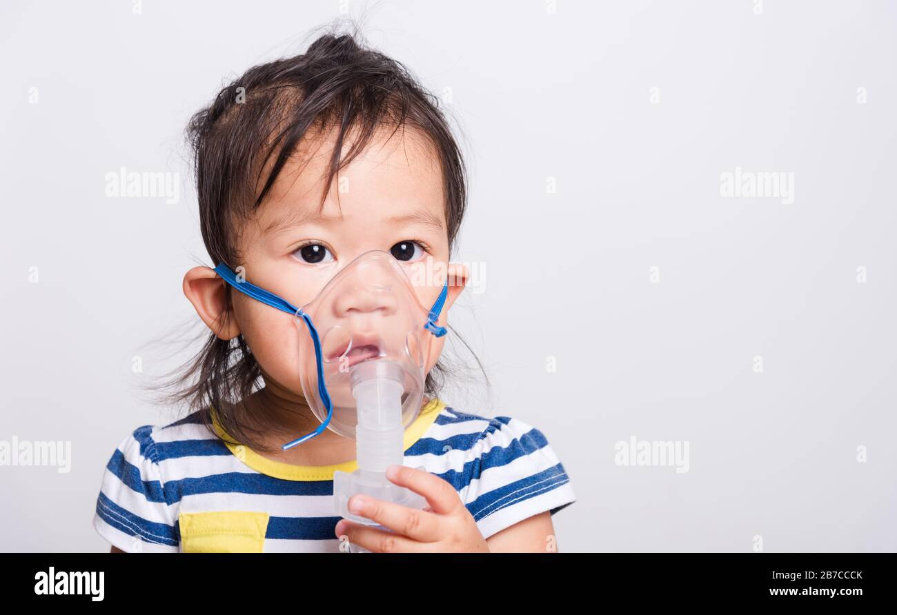 Closeup Asian face, Little baby girl sick her using steam inhaler ...