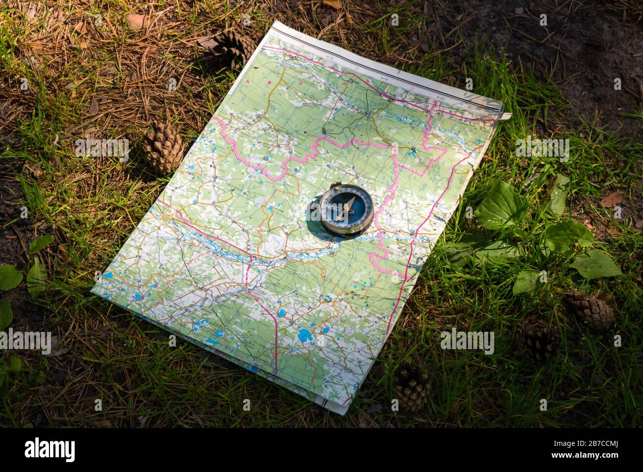 map and compass on a path in the woods Stock Photo - Alamy