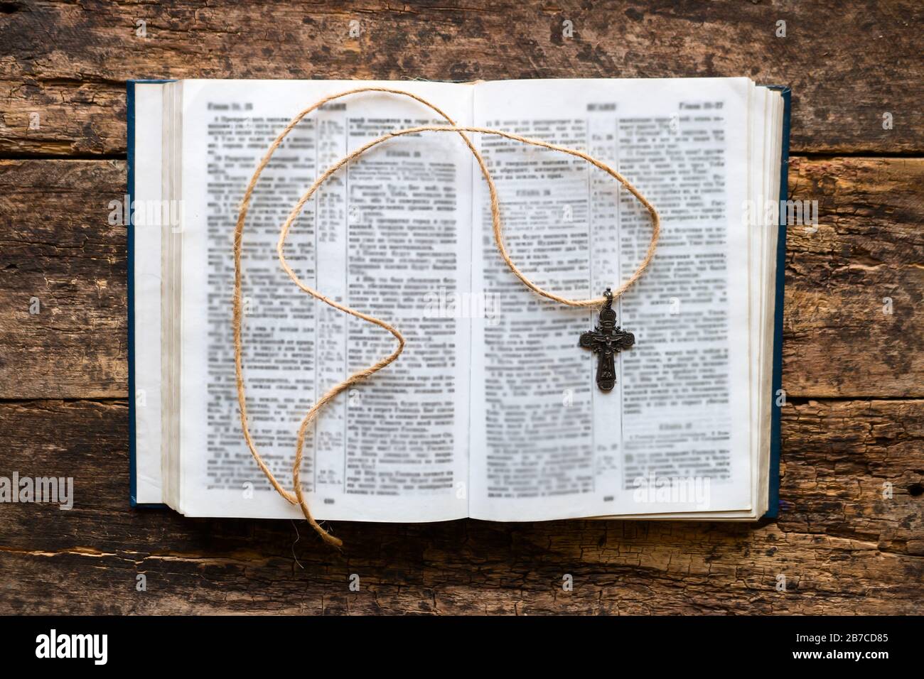 Open bible and cross on a wooden background Stock Photo - Alamy