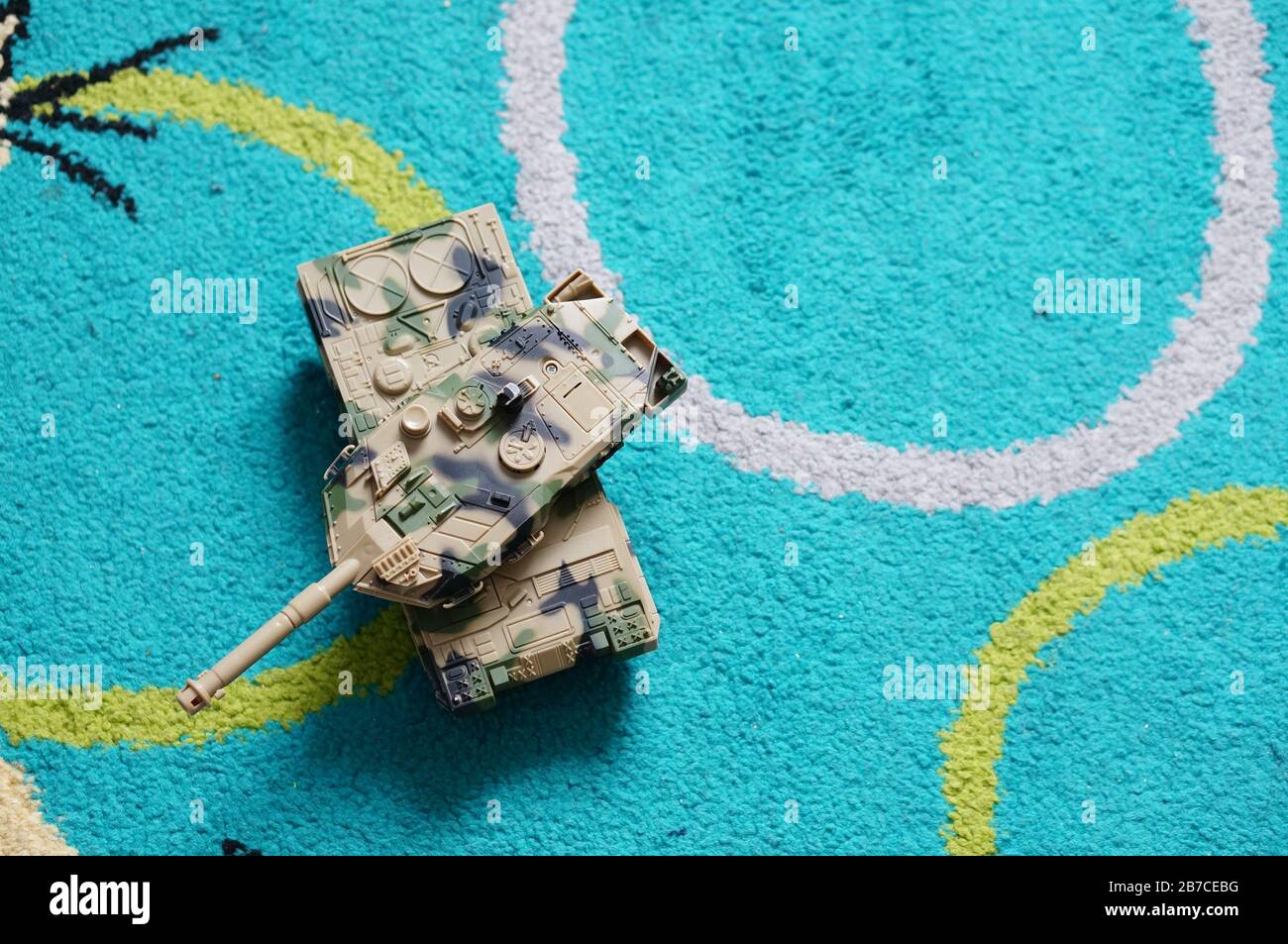 Overhead shot of a tank toy on the blue surface with drawings Stock ...