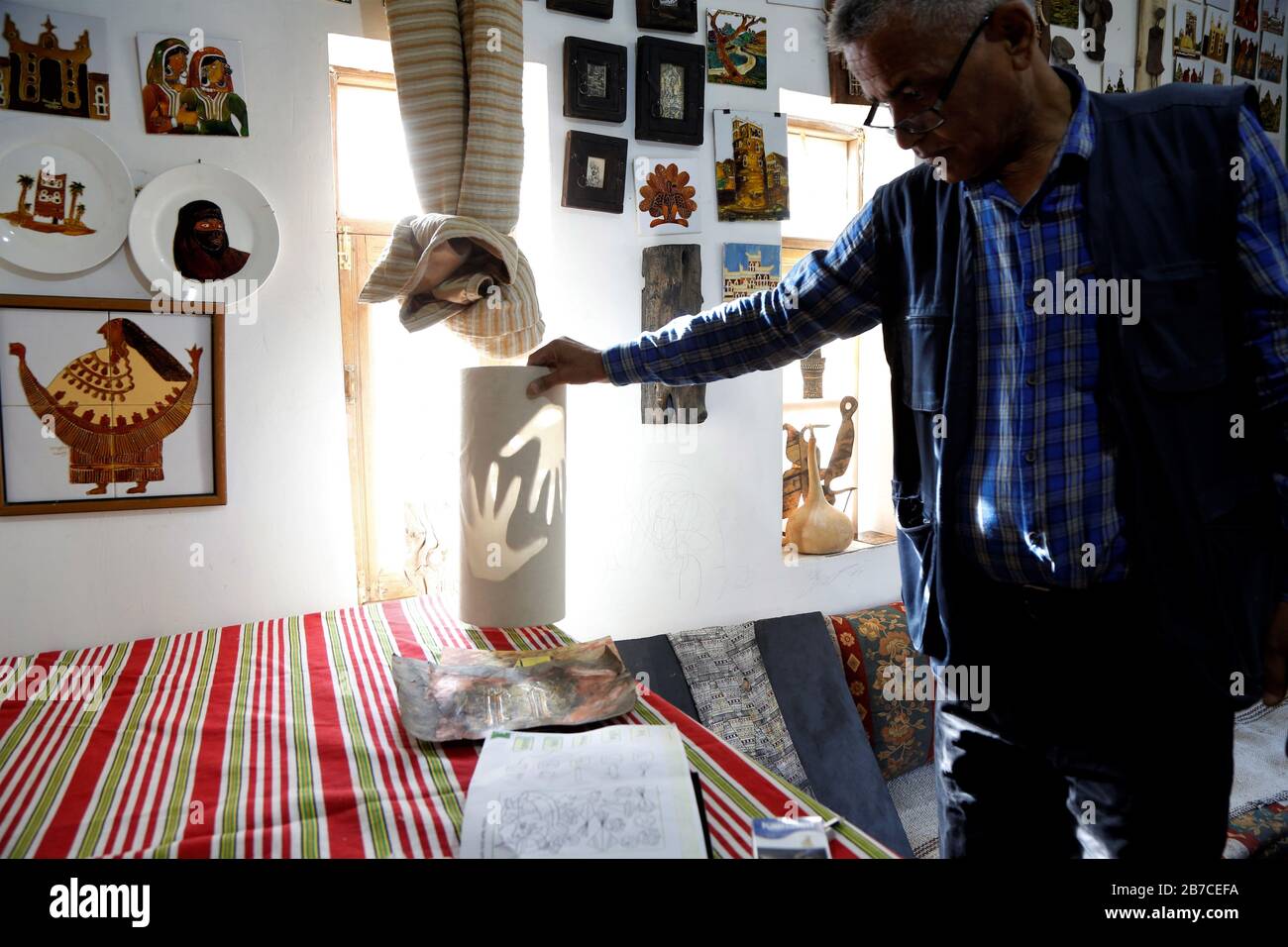 Sanaa, Yemen. 4th Mar, 2020. Yemeni artist Yassin Ghaleb shows an ...