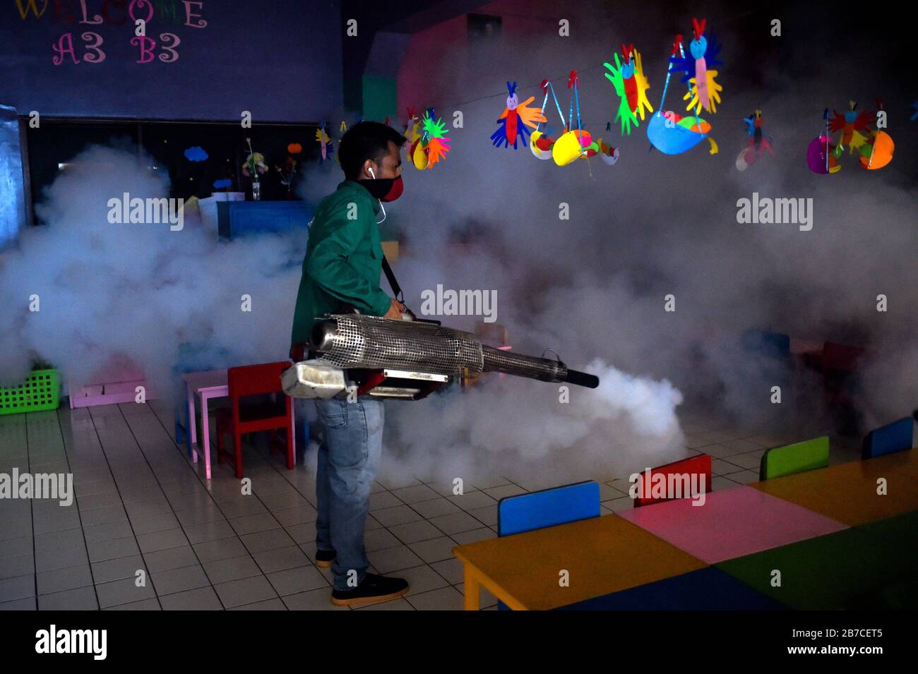 Jakarta, Indonesia. 15th Mar, 2020. A worker sprays anti-mosquito fog ...