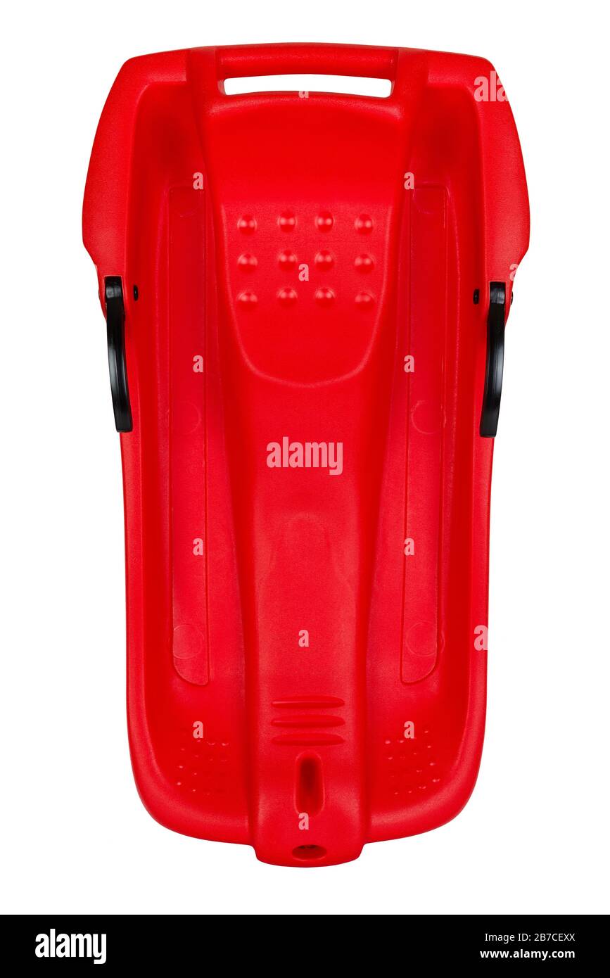 Plastic red sled for skiing on white background Stock Photo - Alamy