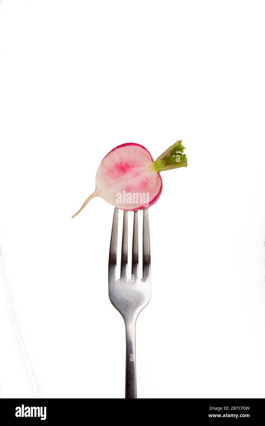 Half a radish on fork with pink middle on white background Stock Photo ...