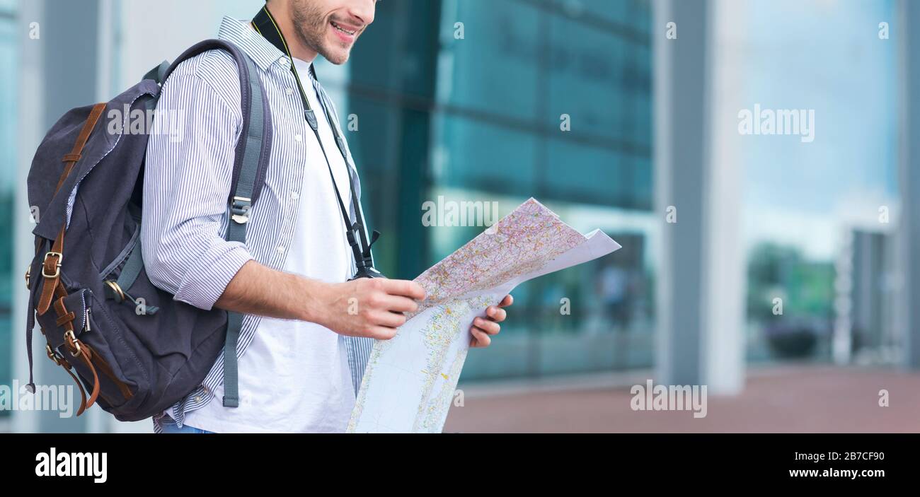 Male tourist map in hands hi-res stock photography and images - Alamy