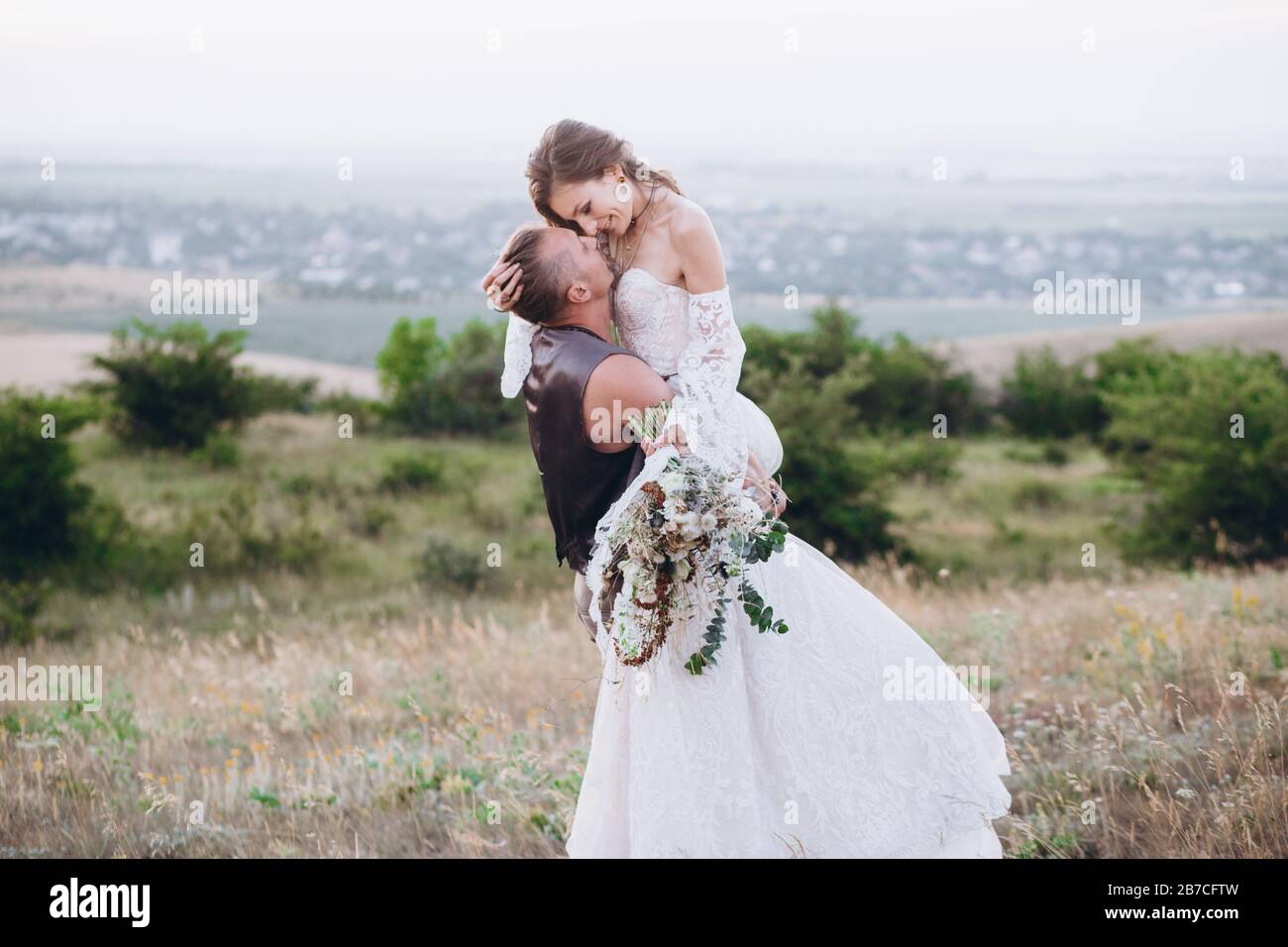Couple in boho style in nature hug each other. Boho style wedding Stock ...