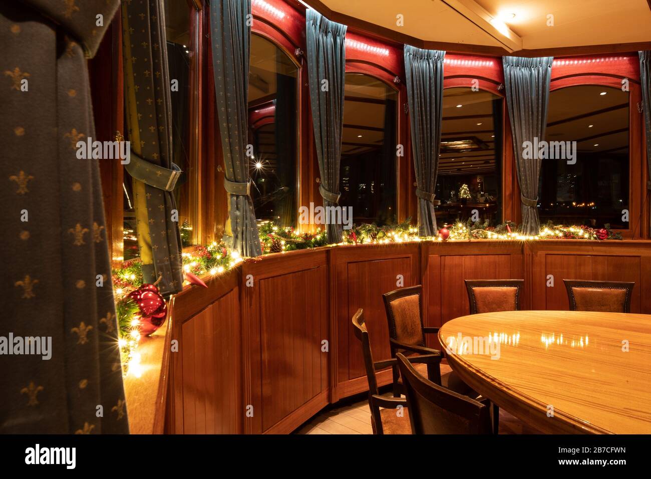 High angle shot of a fancy restaurant with a round wooden table with ...