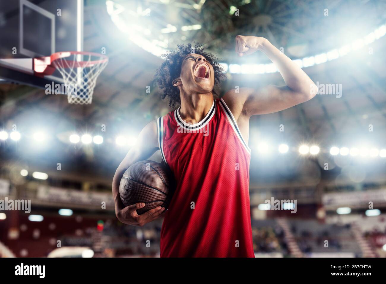 Basketball player wins the match at the basket stadium full of ...