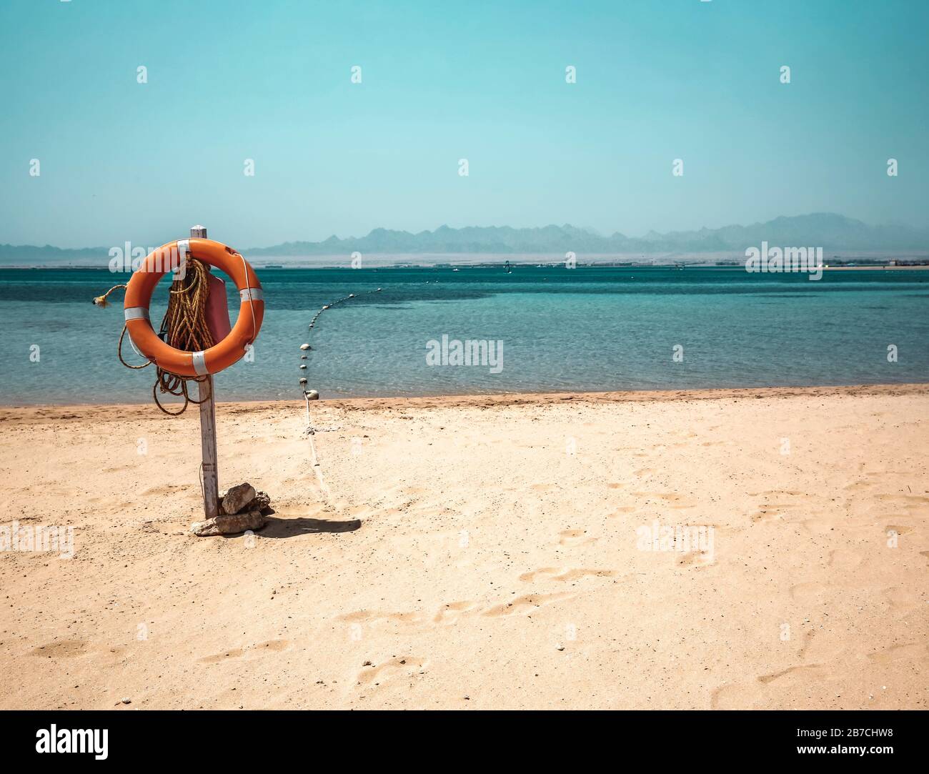 Sunny sandy beach in summer time with sea and blue sky background Stock ...