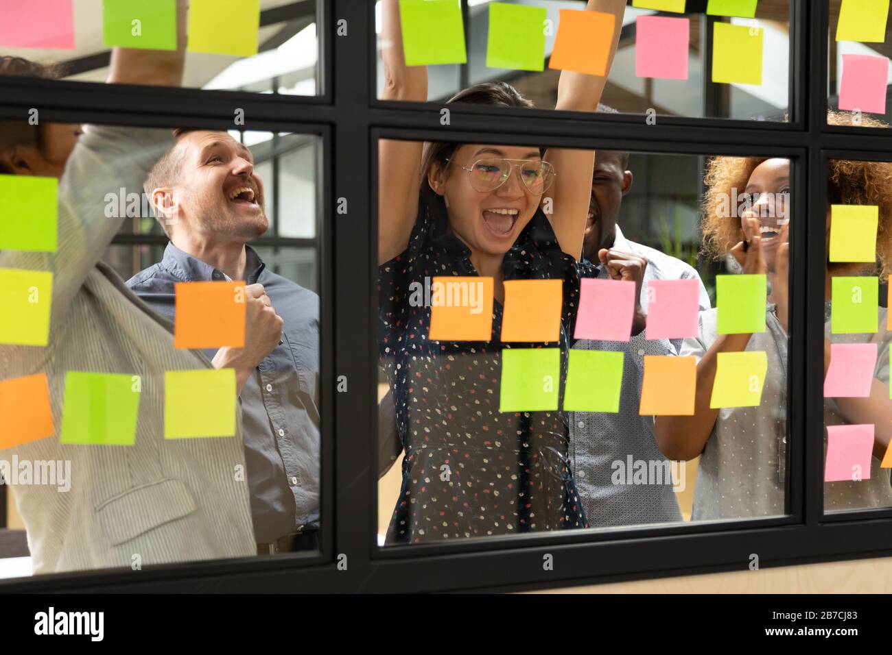 Asian leader with diverse employees team celebrating success at meeting ...