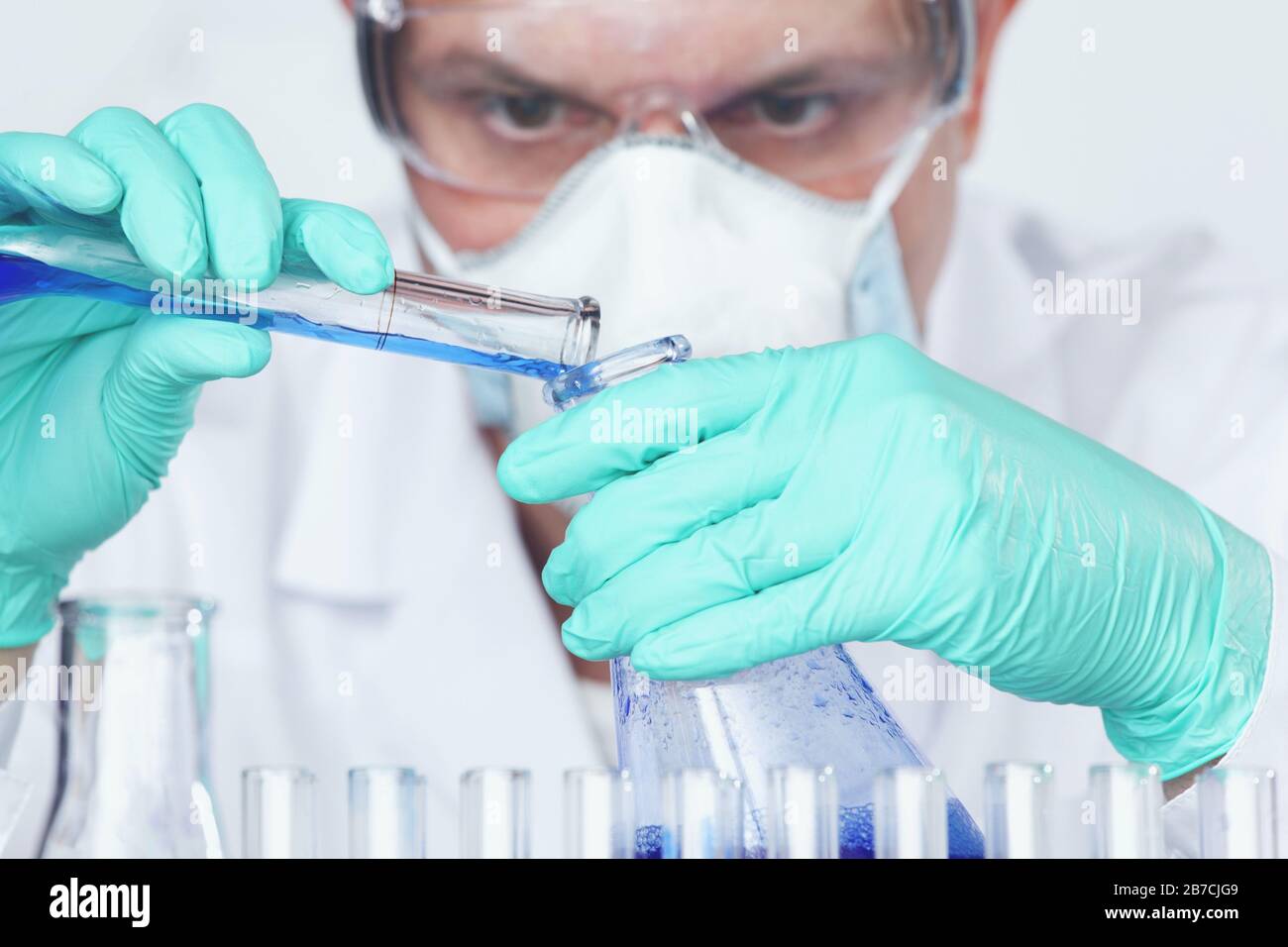 Mature researcher carrying out experiment hi-res stock photography and ...