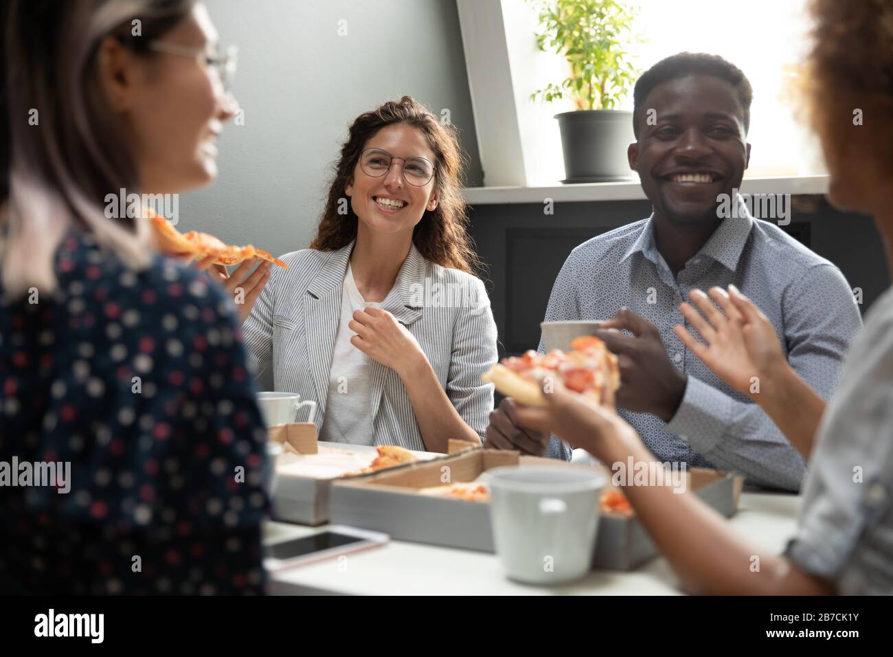 Happy Diverse Colleagues Tasty Eating Pizza Chatting During Lunch