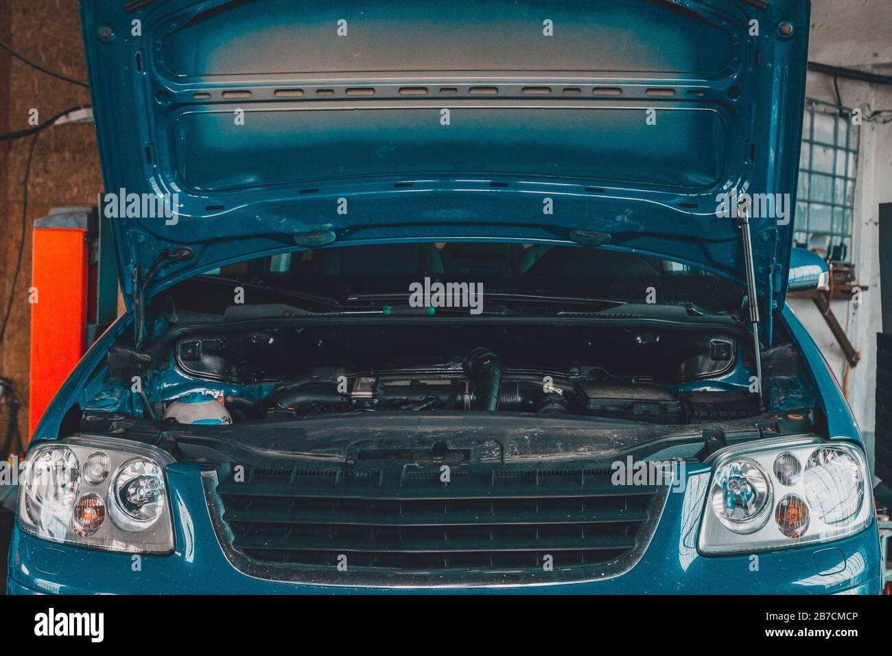European car with rectangular headlights and open hood in blue closeup ...
