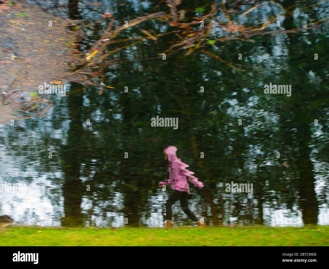 Girl reflected in pond Stock Photo - Alamy