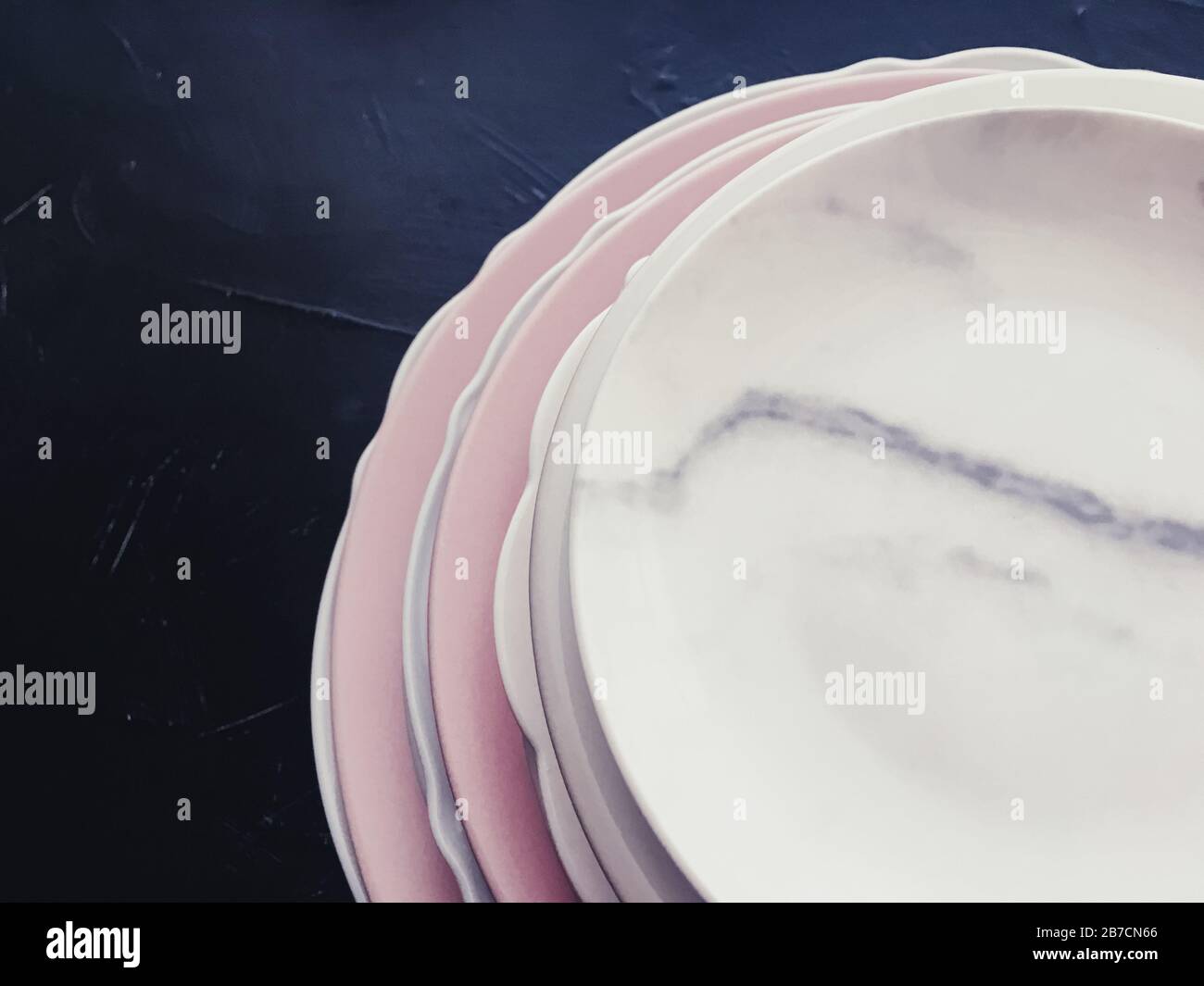 Stack of clean empty plates on black background, luxe dishware and ...