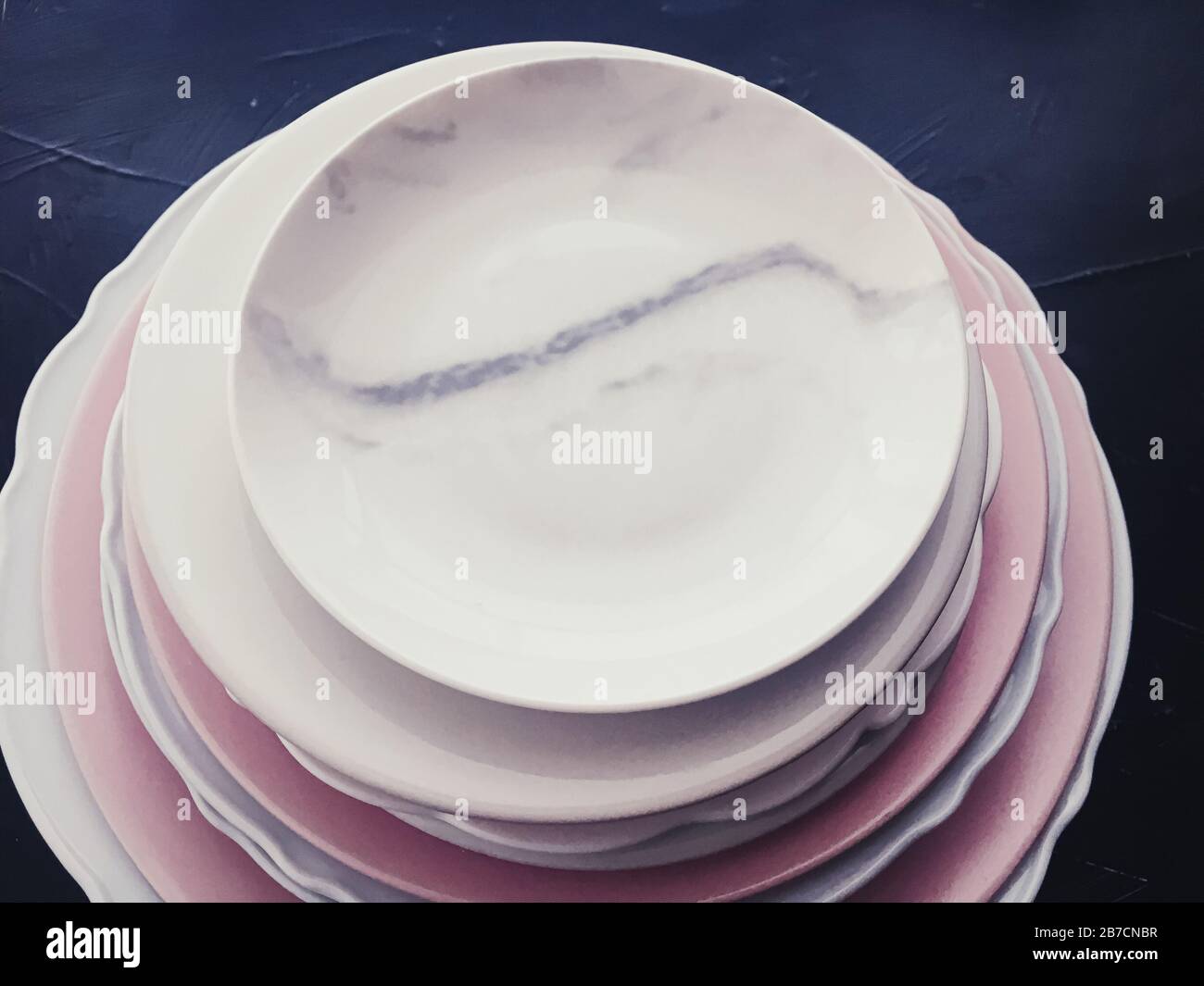Stack of clean empty plates on black background, luxe dishware and ...
