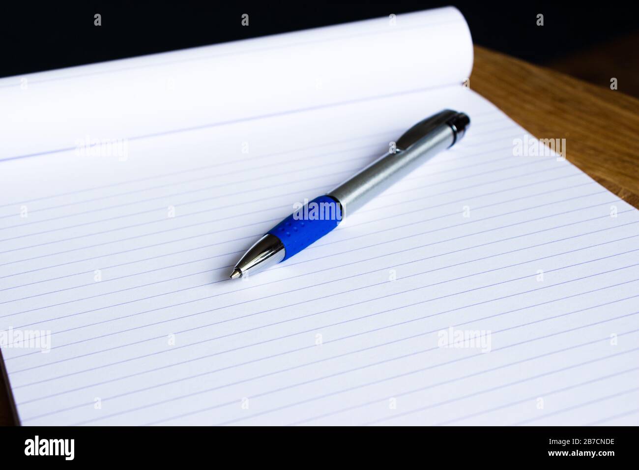Clean notebook with a blue pen on it, background, study, learning, work ...