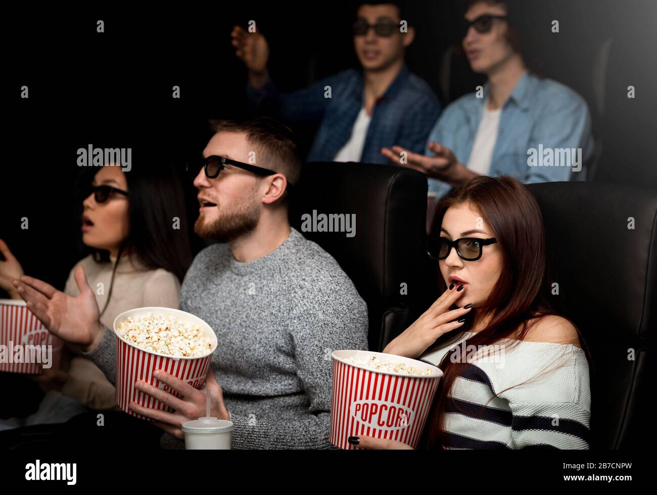 Showtime concept. Excited young people in 3D glasses watching ...