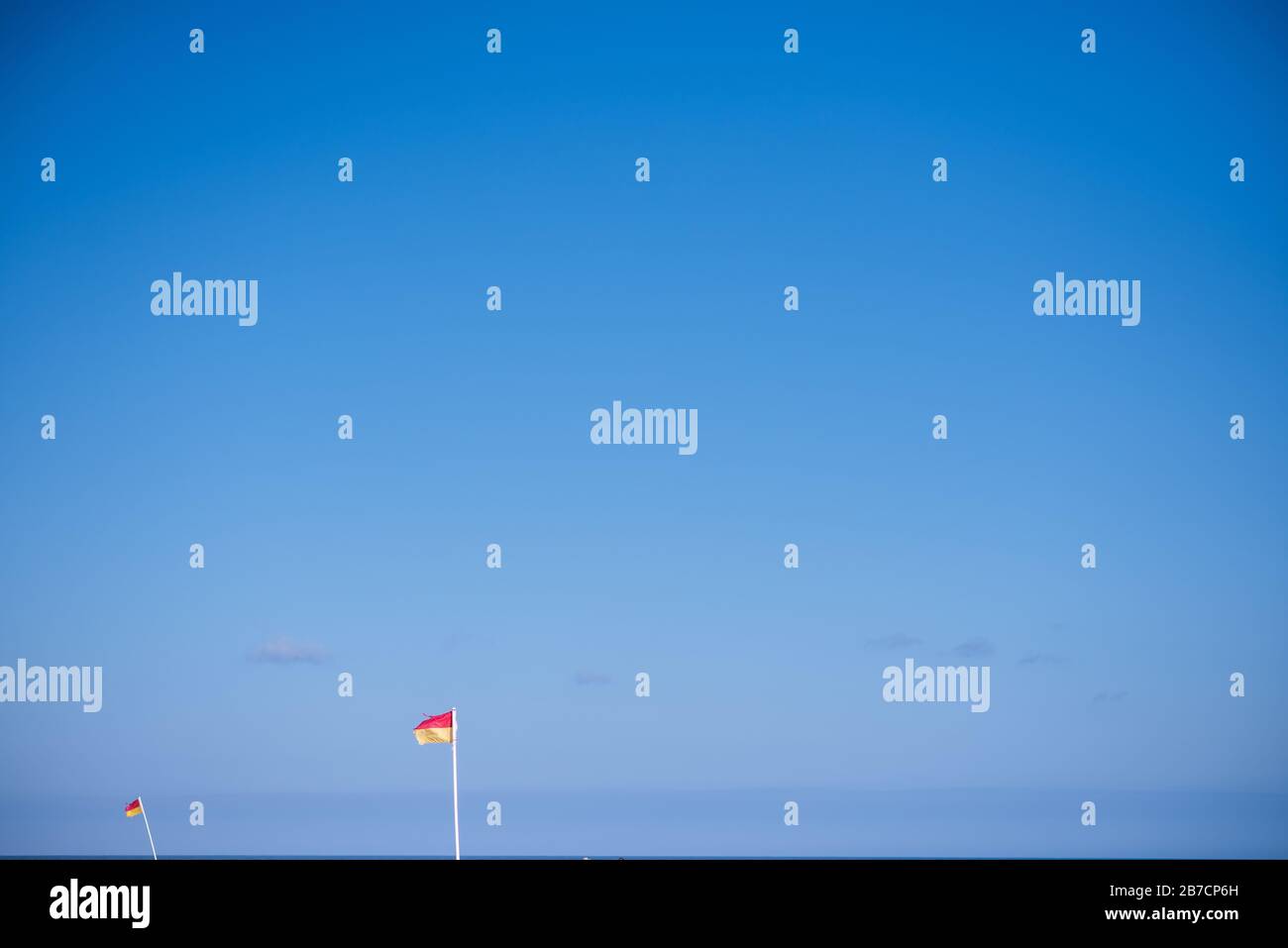 Red over yellow flag indicating safe space to swim under supervision ...