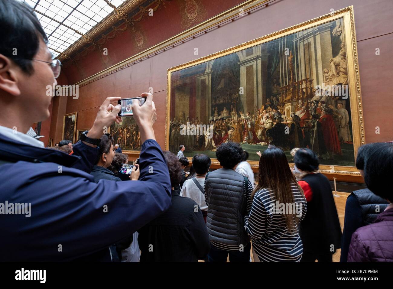 Crowd of asian tourists in front of The Coronation of Napoleon oil ...