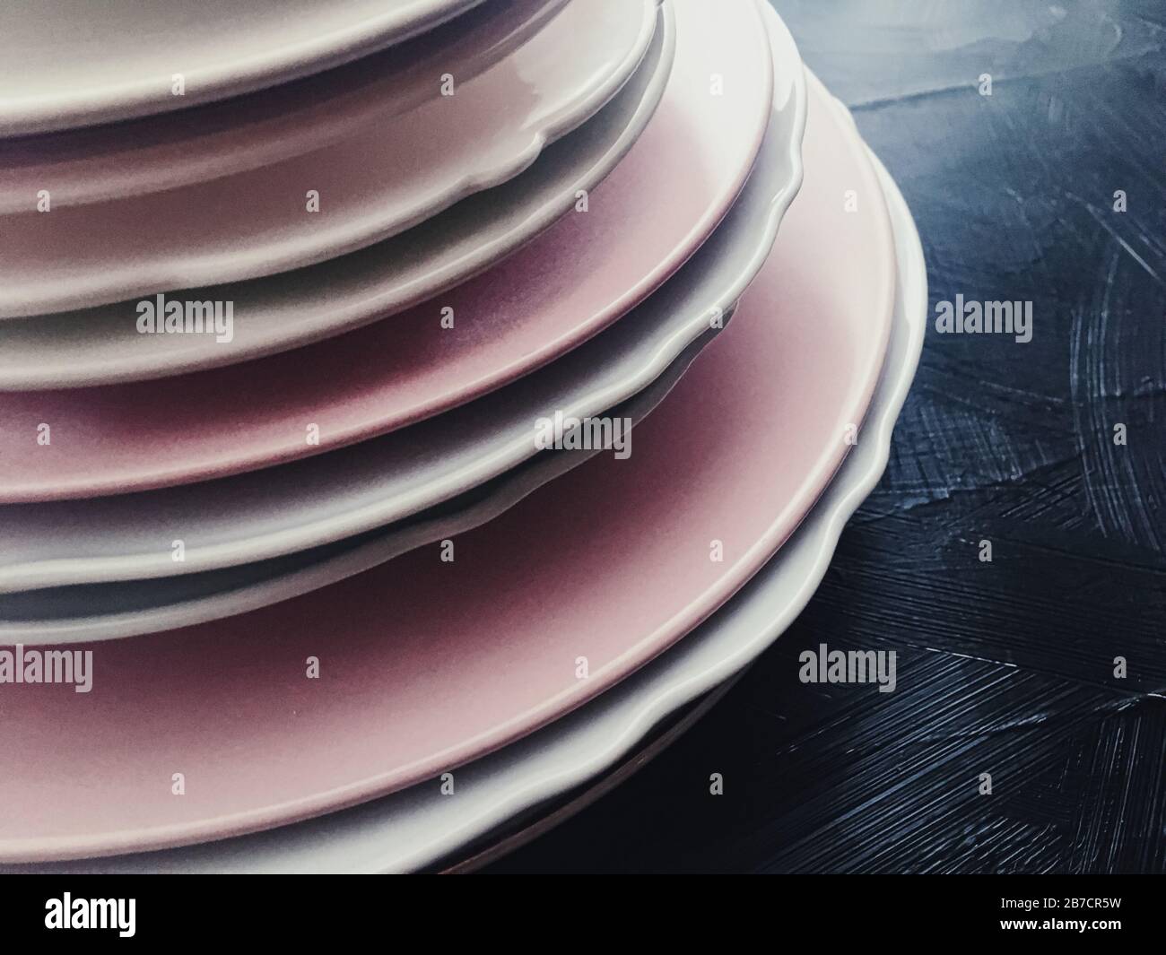 Stack of clean empty plates on black background, luxe dishware and ...