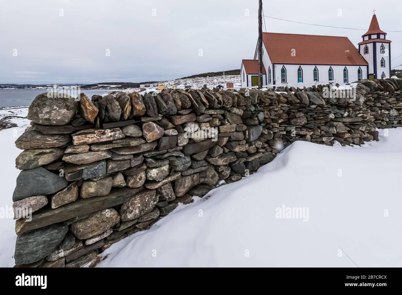 All Saints Anglican Church behind a dry stone wall art installation in ...