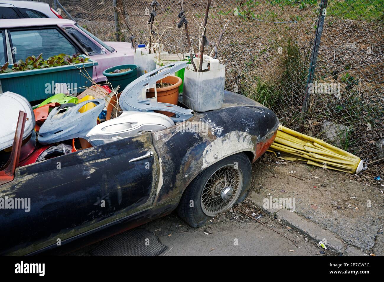 Classic vintage wrecked junk cars in the street Stock Photo - Alamy