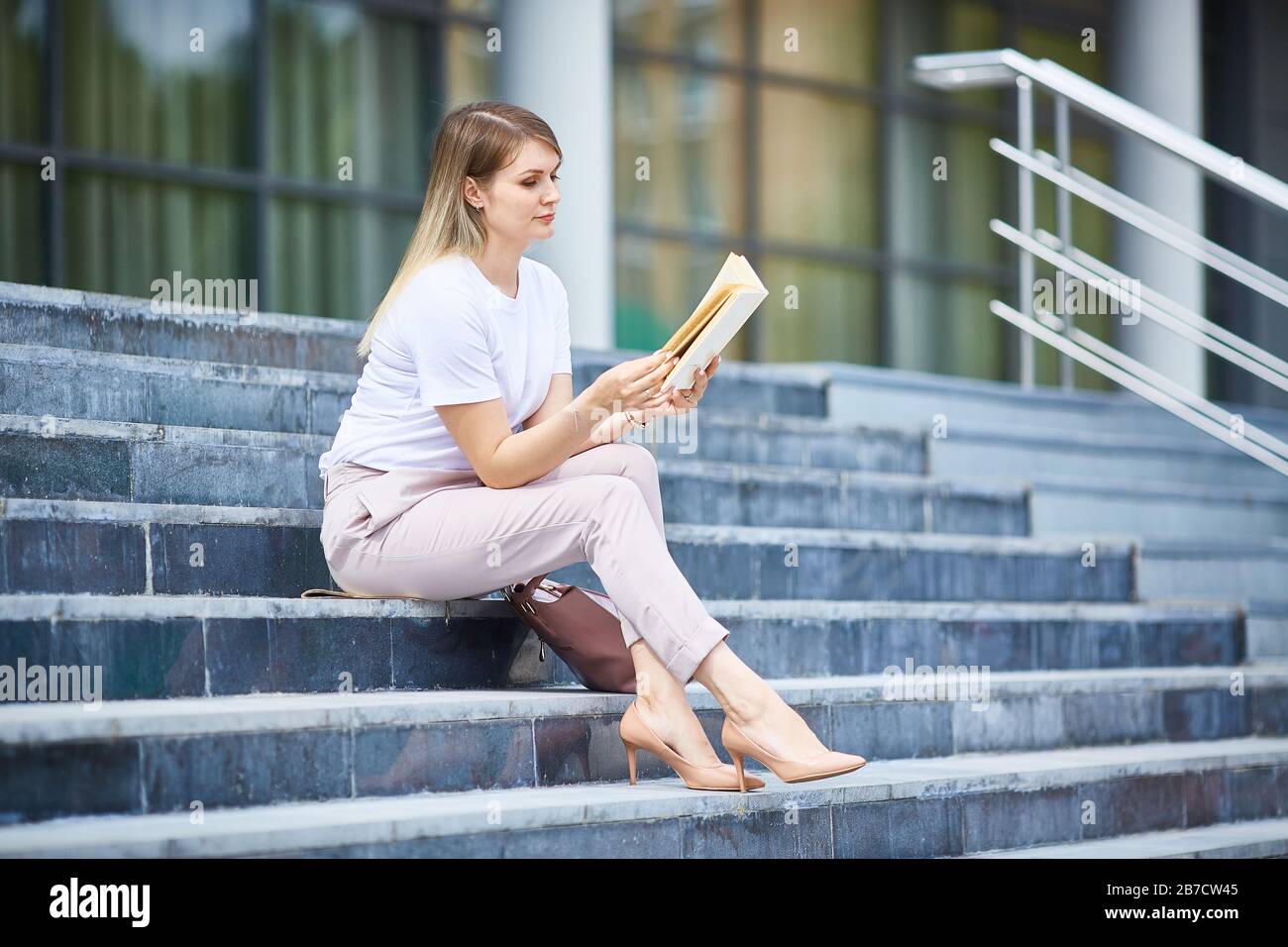Reading book on steps hi-res stock photography and images - Alamy