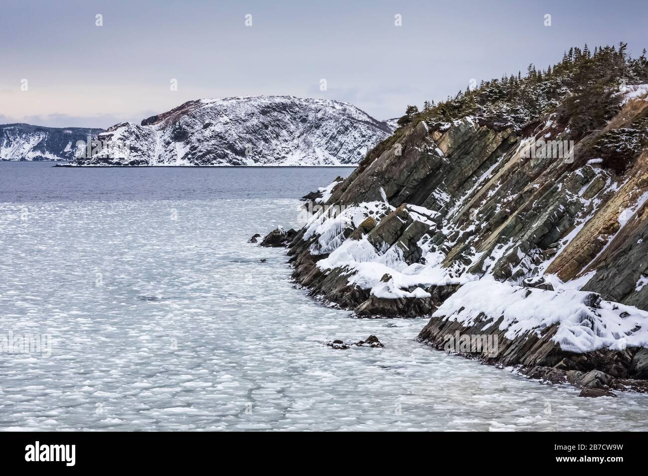 Winter seascape with rocky cliffs in English Harbour of Newfoundland ...