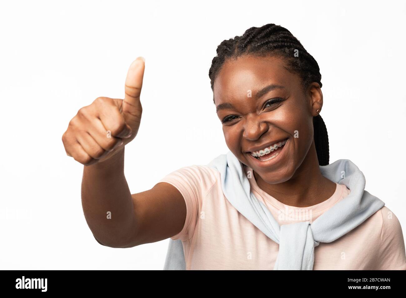 Smiling African American Girl Gesturing Thumbs-Up Over White Background ...